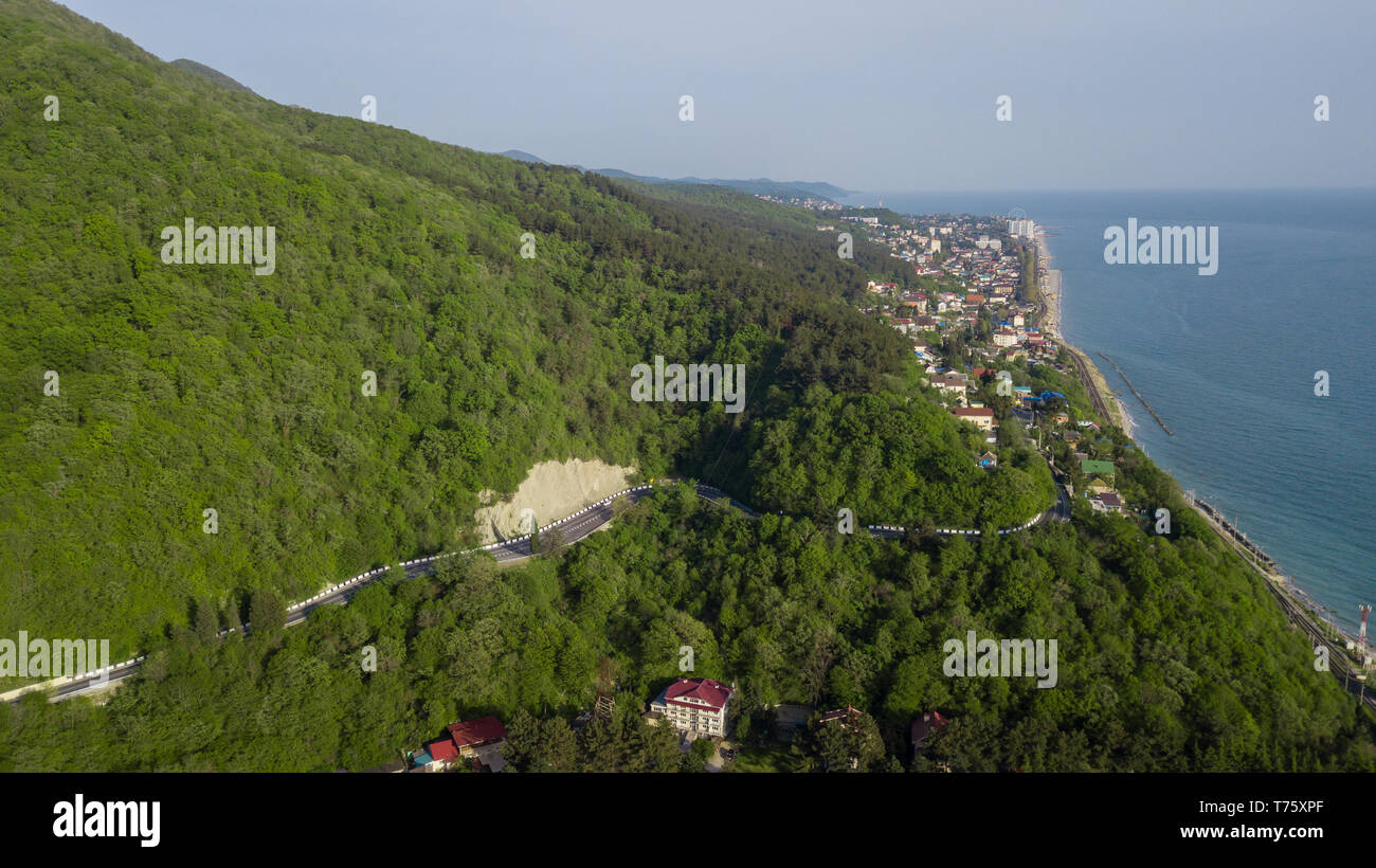 Aerial view over mountain road going through forest landscape, Winding ...
