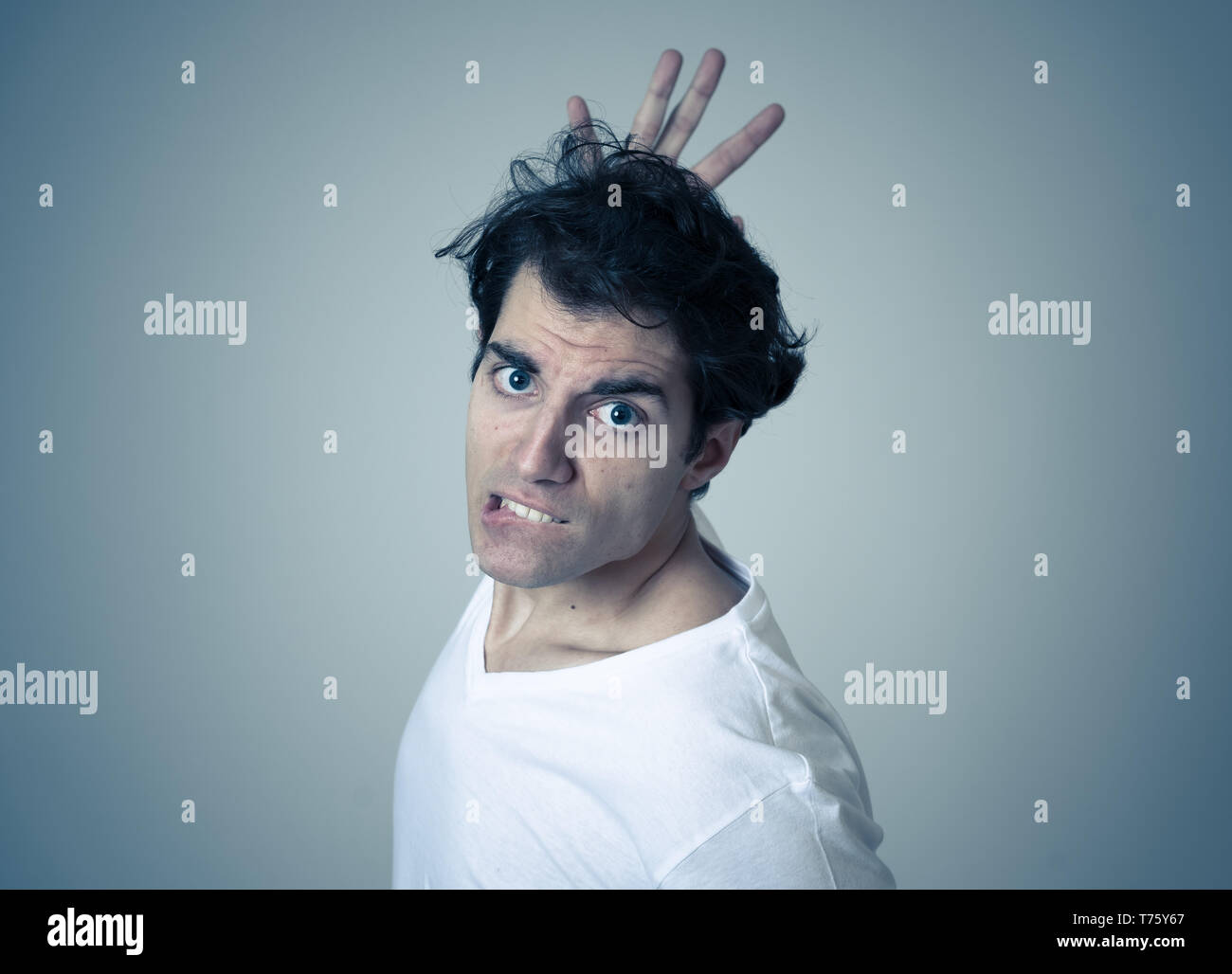 Close up portrait of young caucasian male with angry face. Looking ...