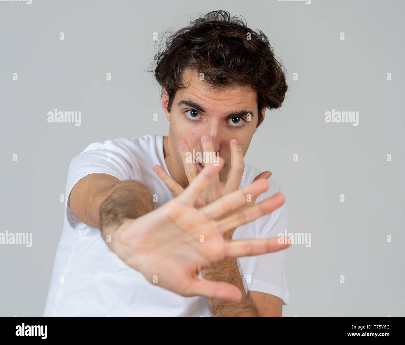 Portrait of Handsome latin young man in shock with a scared expression ...