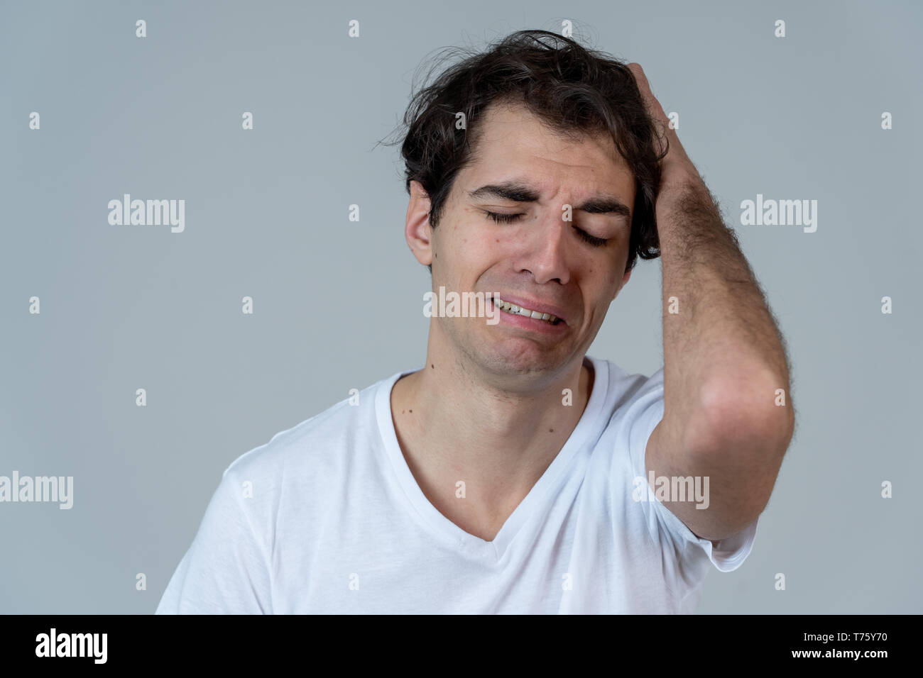 Portrait of young sad man crying in emotional pain looking desperate ...