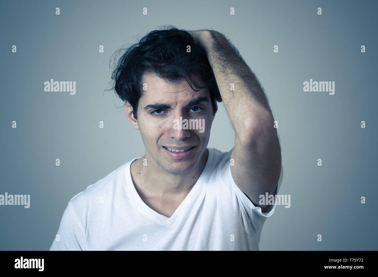 Portrait of young sad man crying in emotional pain looking desperate ...