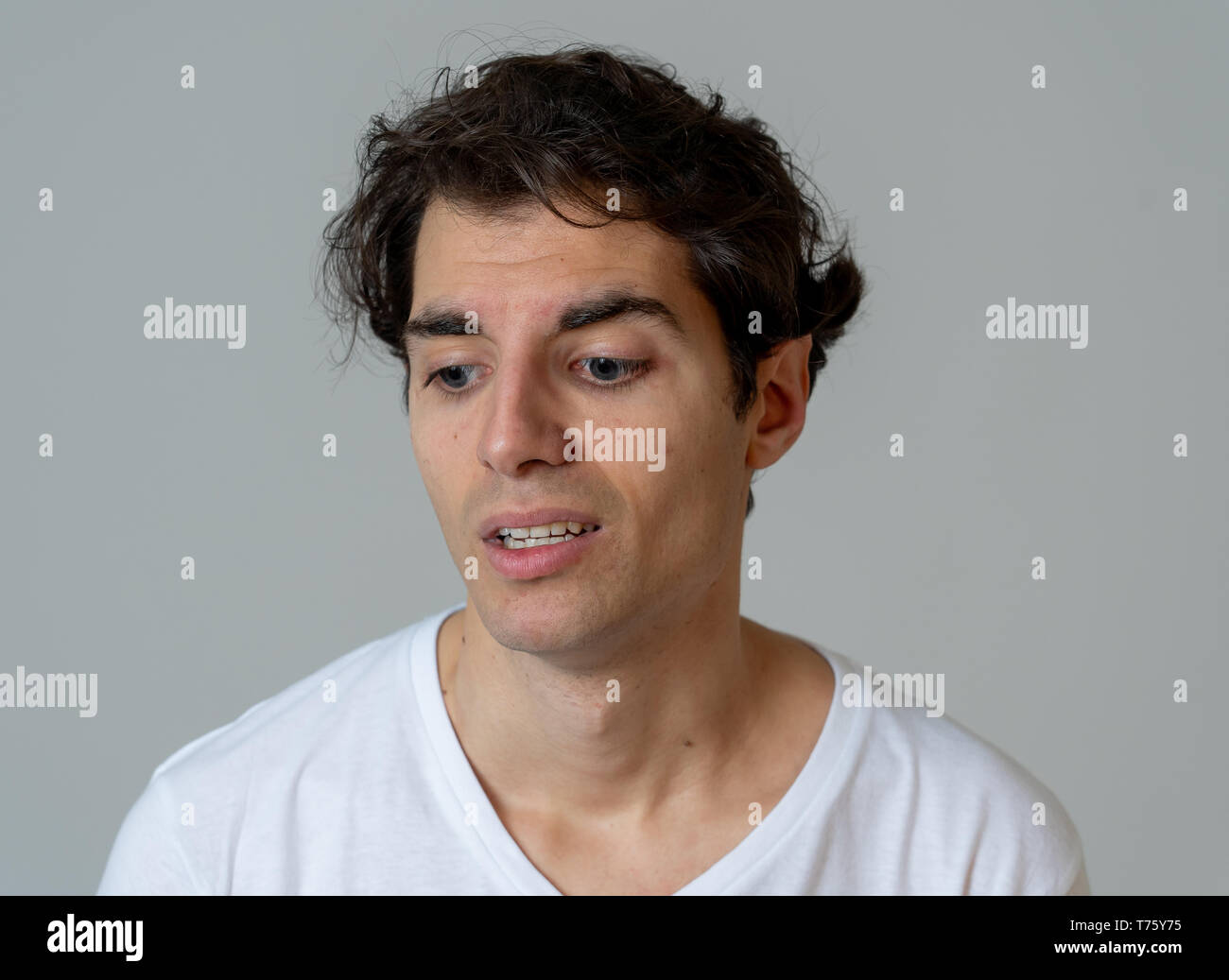 Young man feeling confused and displeased staring in disgust. Looking ...