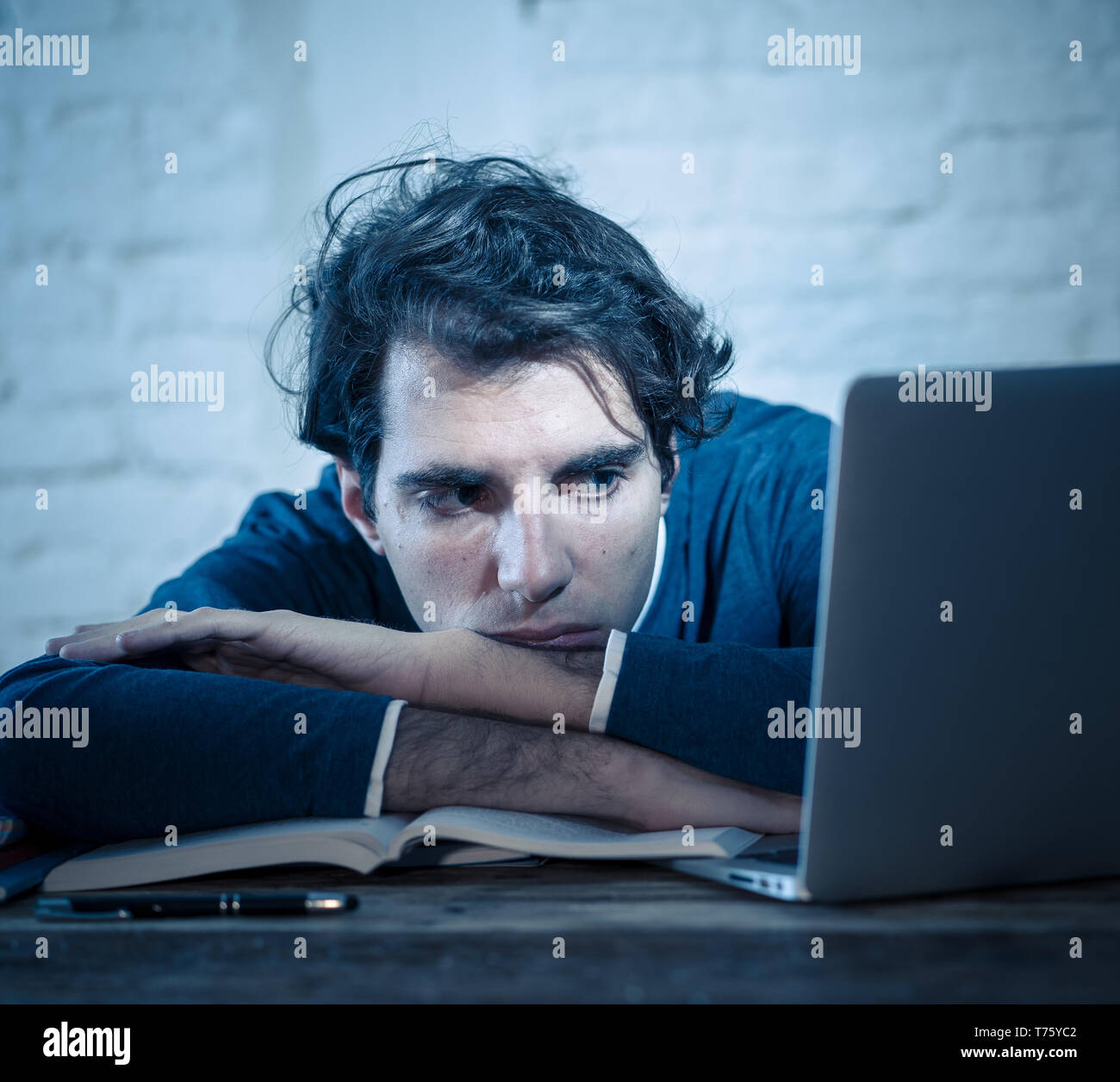 Young University student feeling tired and overwhelmed studying at ...