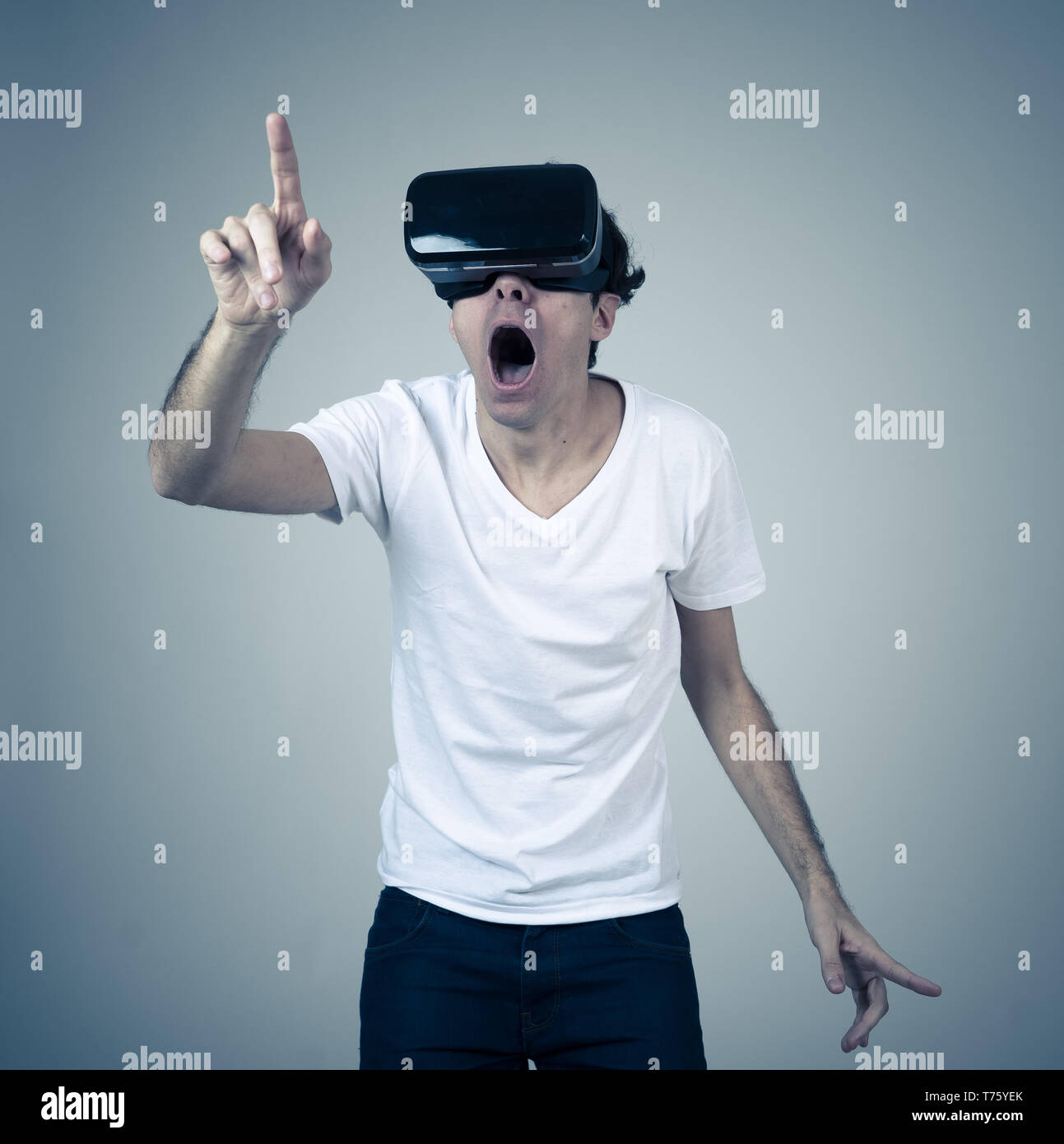 Amazed funny man using VR headset glasses touching and interacting with ...