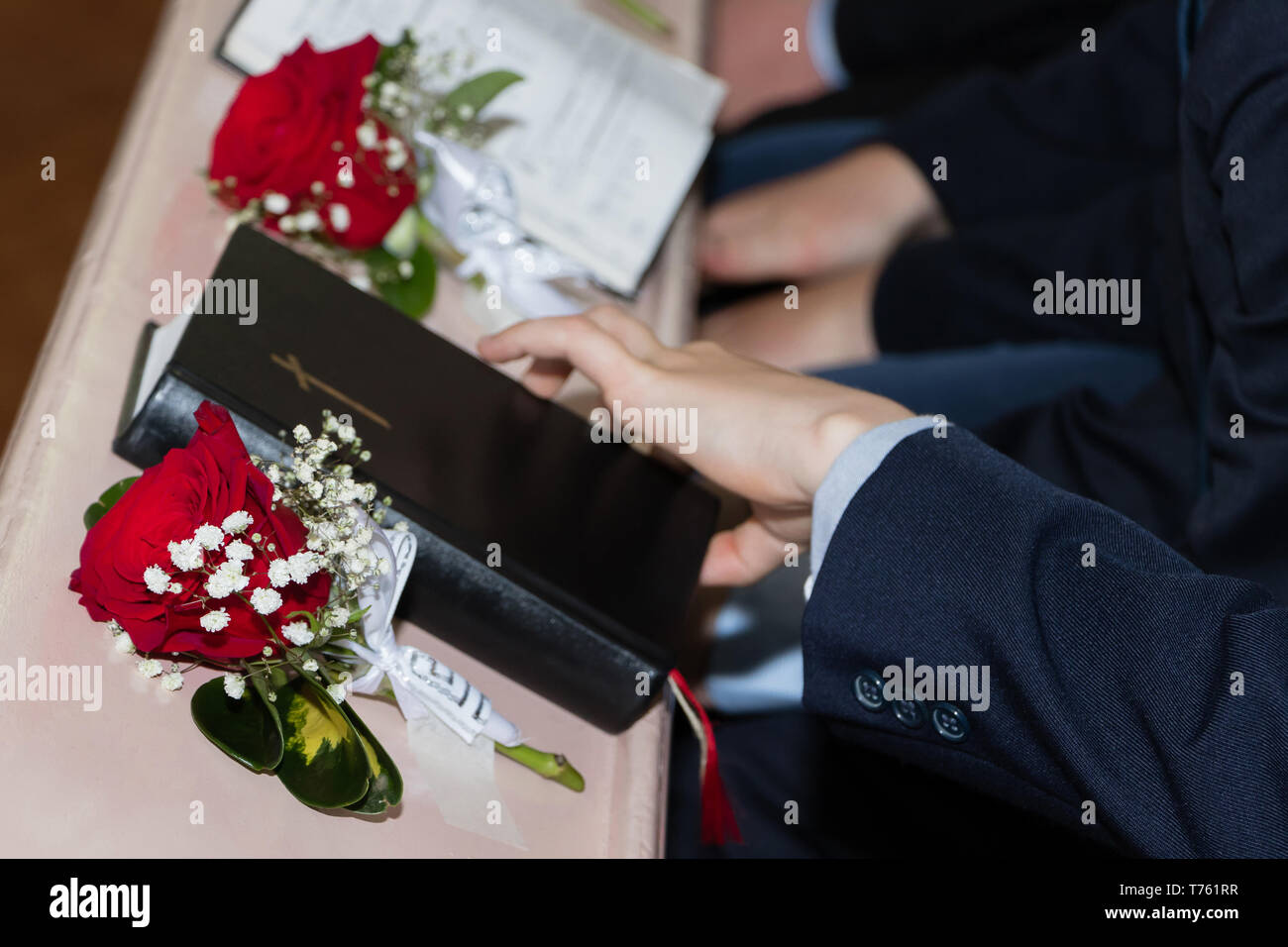 A picture of the Holy Bible with red roses in church Stock Photo - Alamy