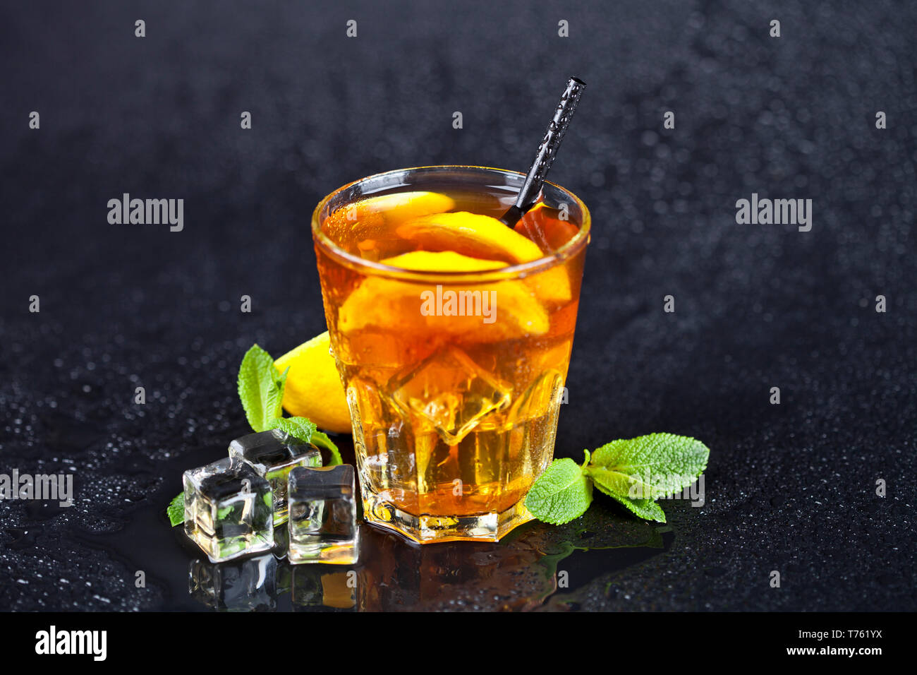 Traditional fresh iced tea with lemon, mint leaves and ice cubes in ...