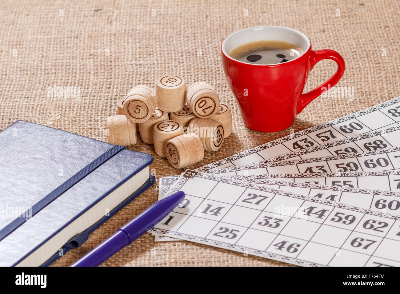 Board game lotto on sackcloth. Wooden lotto barrels and game cards for ...