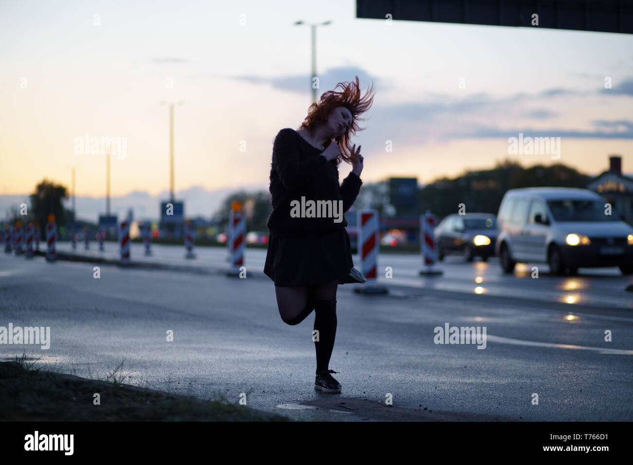 Active traveler dancer woman performing on a road construction site at ...