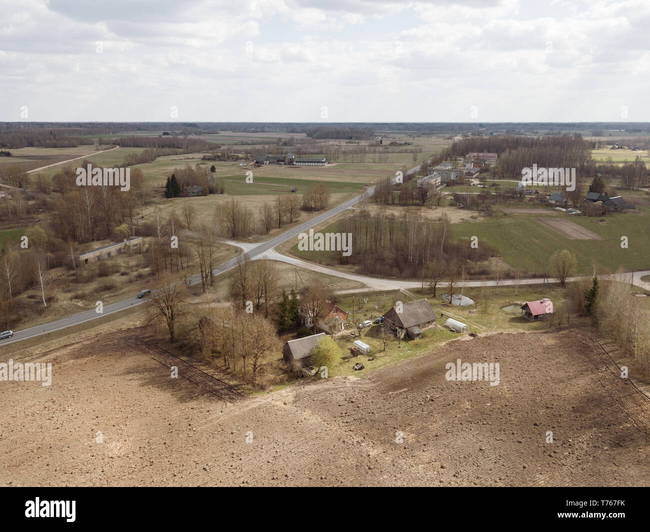 aerial view of countryside fields and forests with small lakes in ...