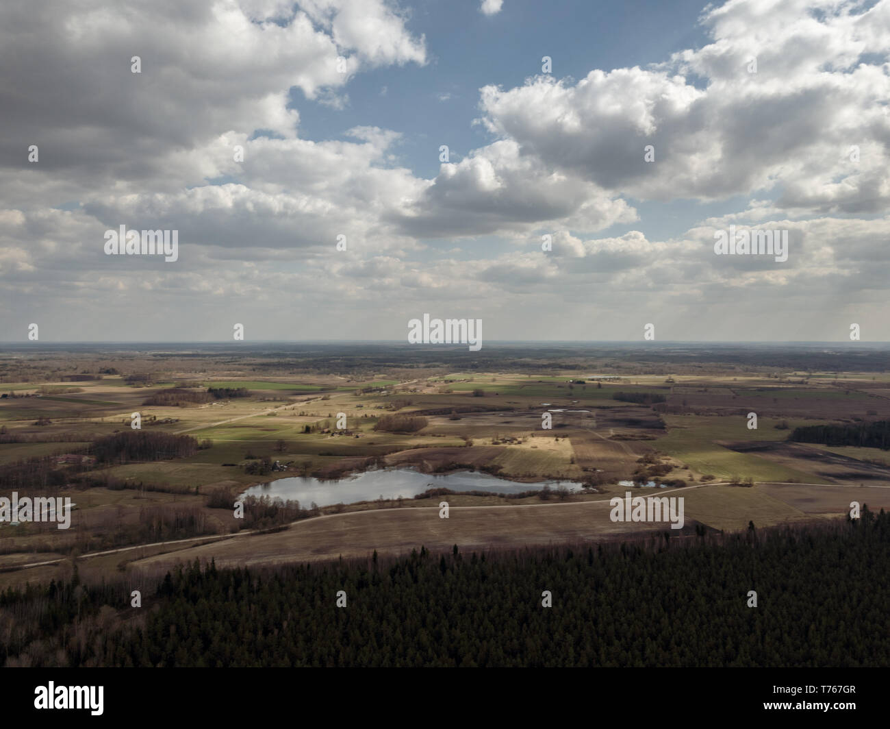 aerial view of countryside fields and forests with small lakes in ...