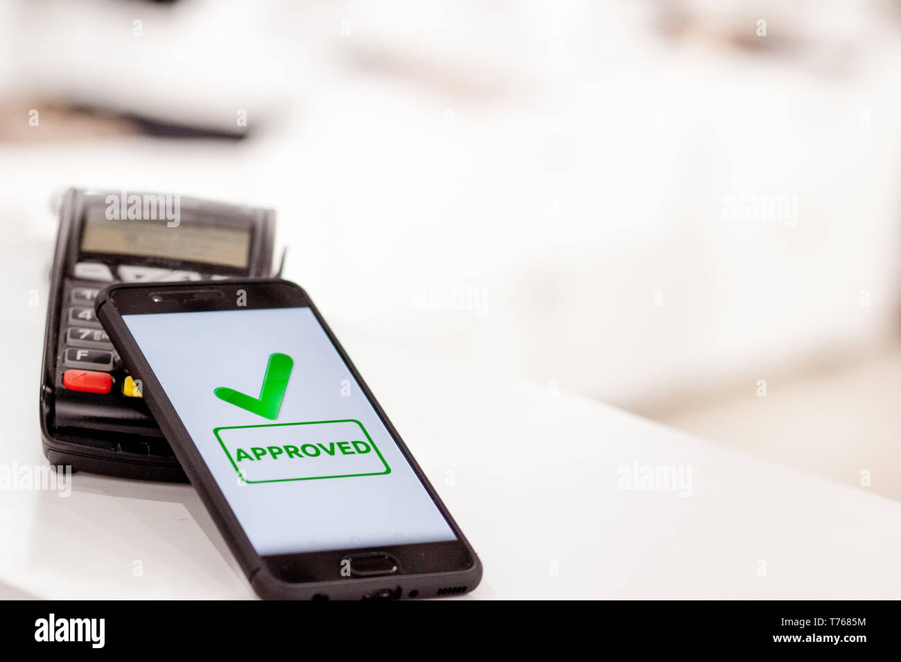 POS terminal, Payment Machine with mobile phone on store background ...