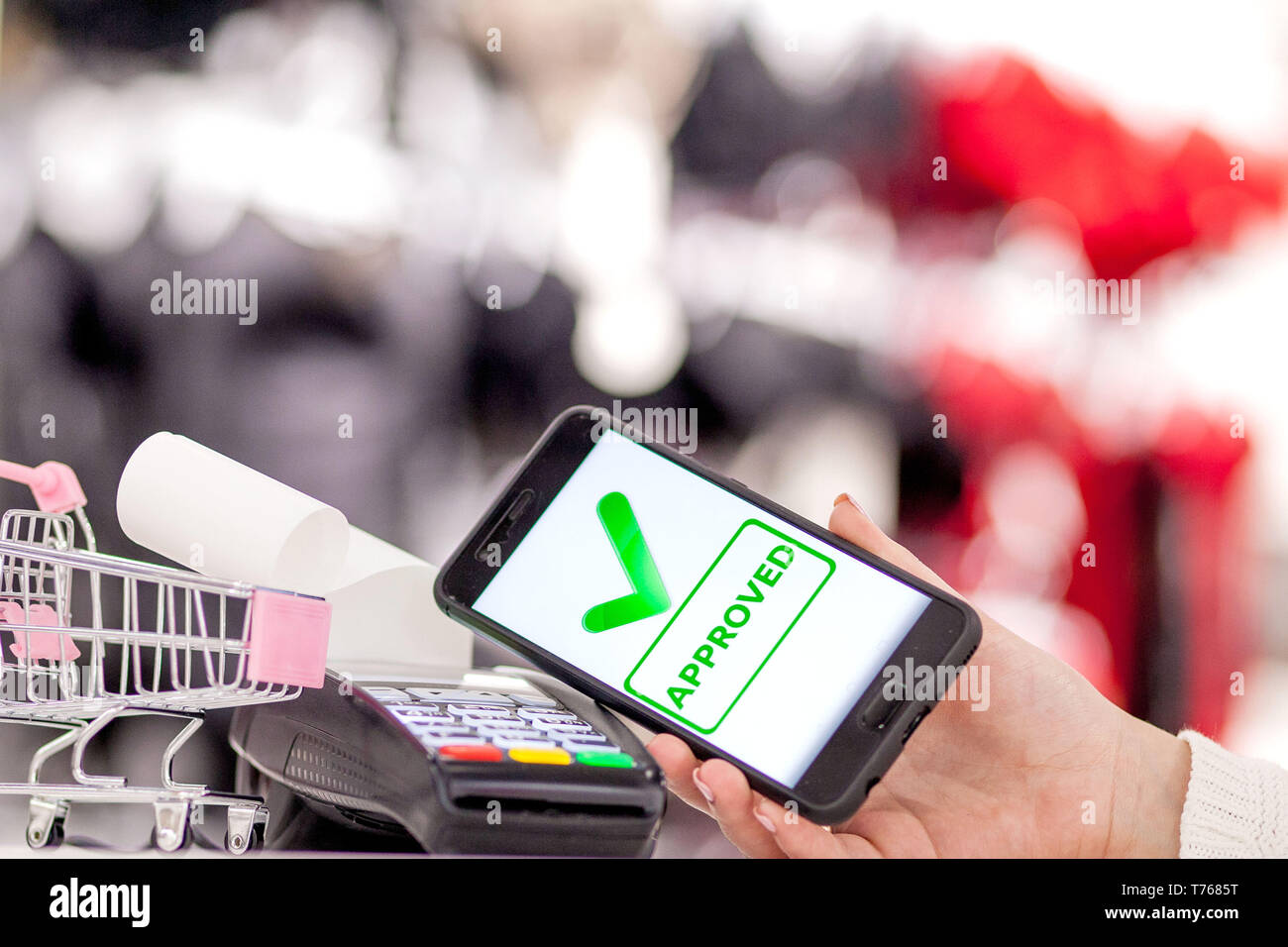 POS terminal, Payment Machine with mobile phone on store background ...