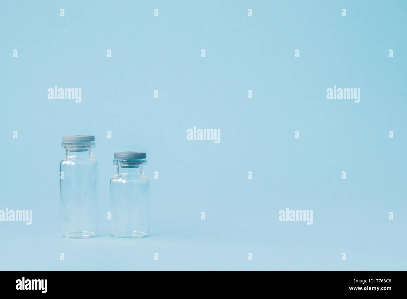 Vial of medicine on blue background with copy space. Antibiotic or ...