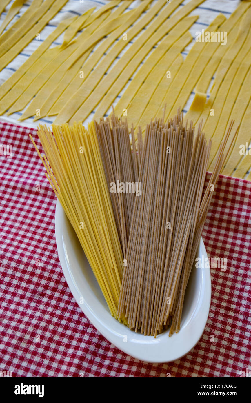 combination of wholemeal and normal spaghetti with on the background ...