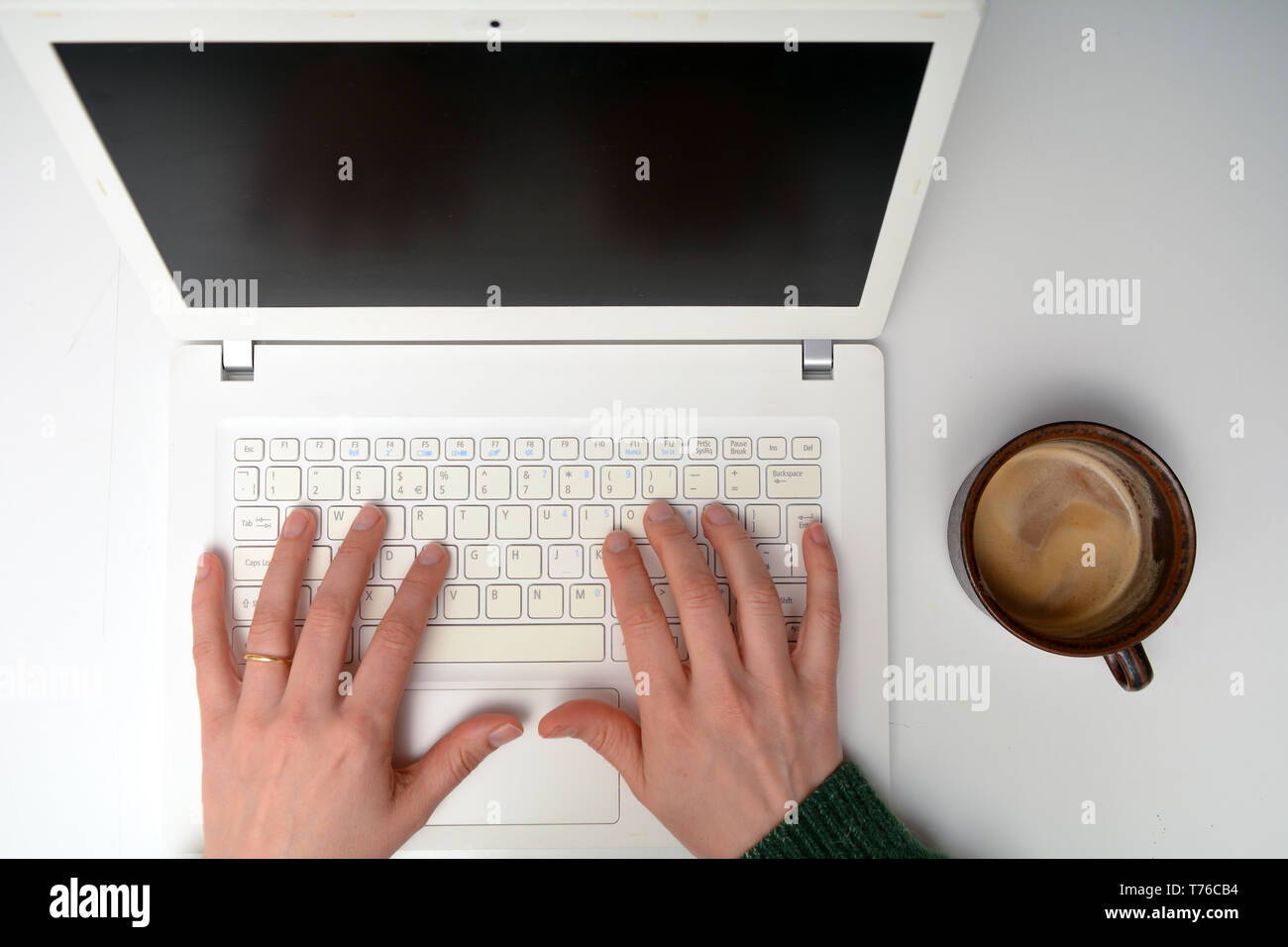 Overhead angle of female entrepreneur businesswoman typing on laptop ...