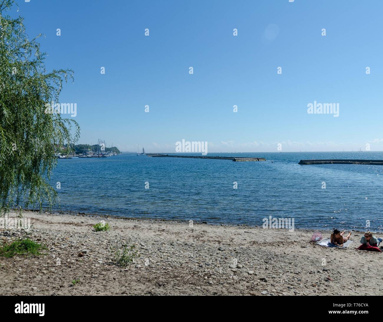 Two beach-goers relax on the shores of Lake Ontario, Canada Stock Photo ...