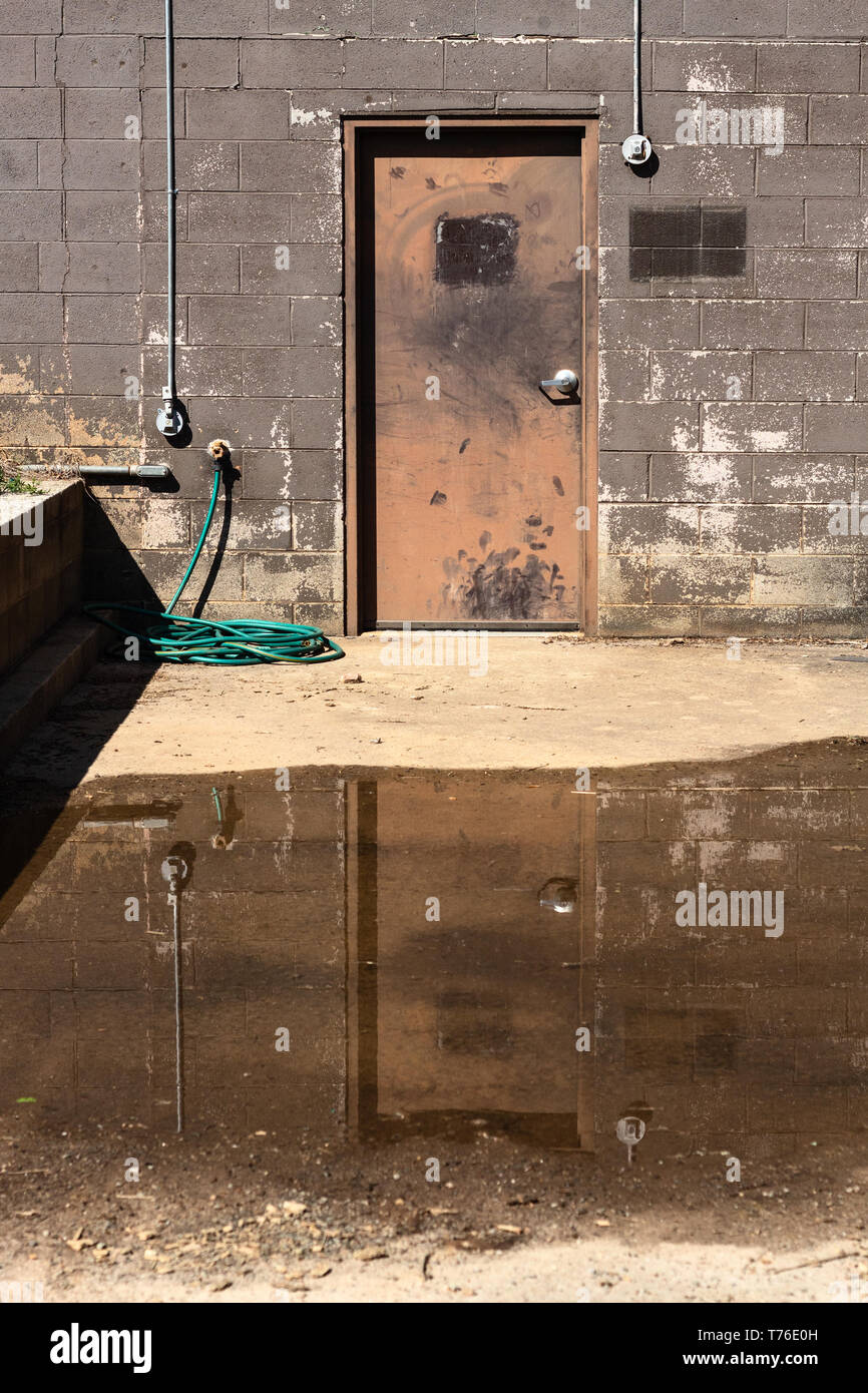 A door is reflected in a puddle of water Stock Photo - Alamy