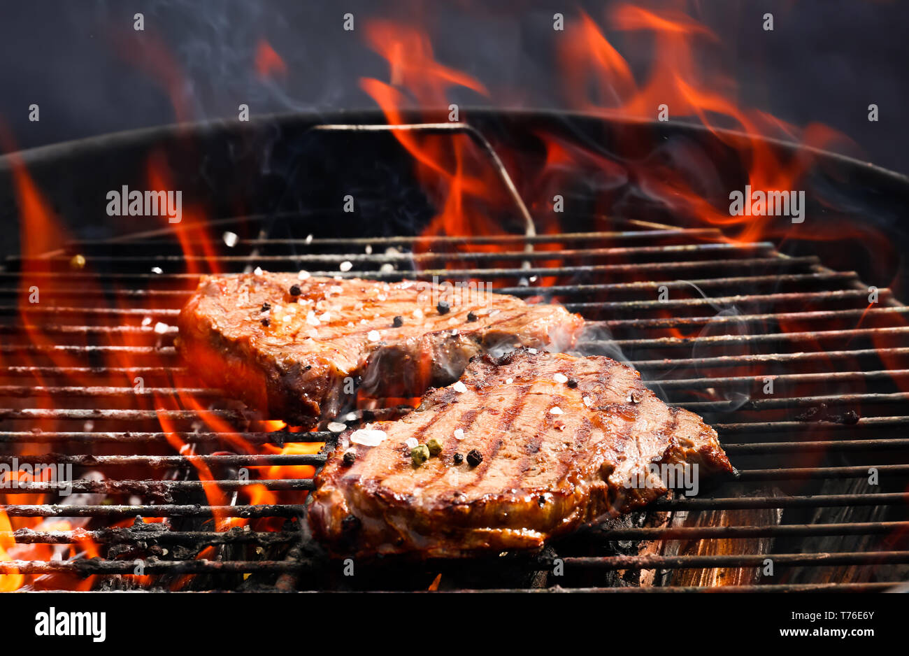 Delicious cooked meat on barbecue grill Stock Photo - Alamy