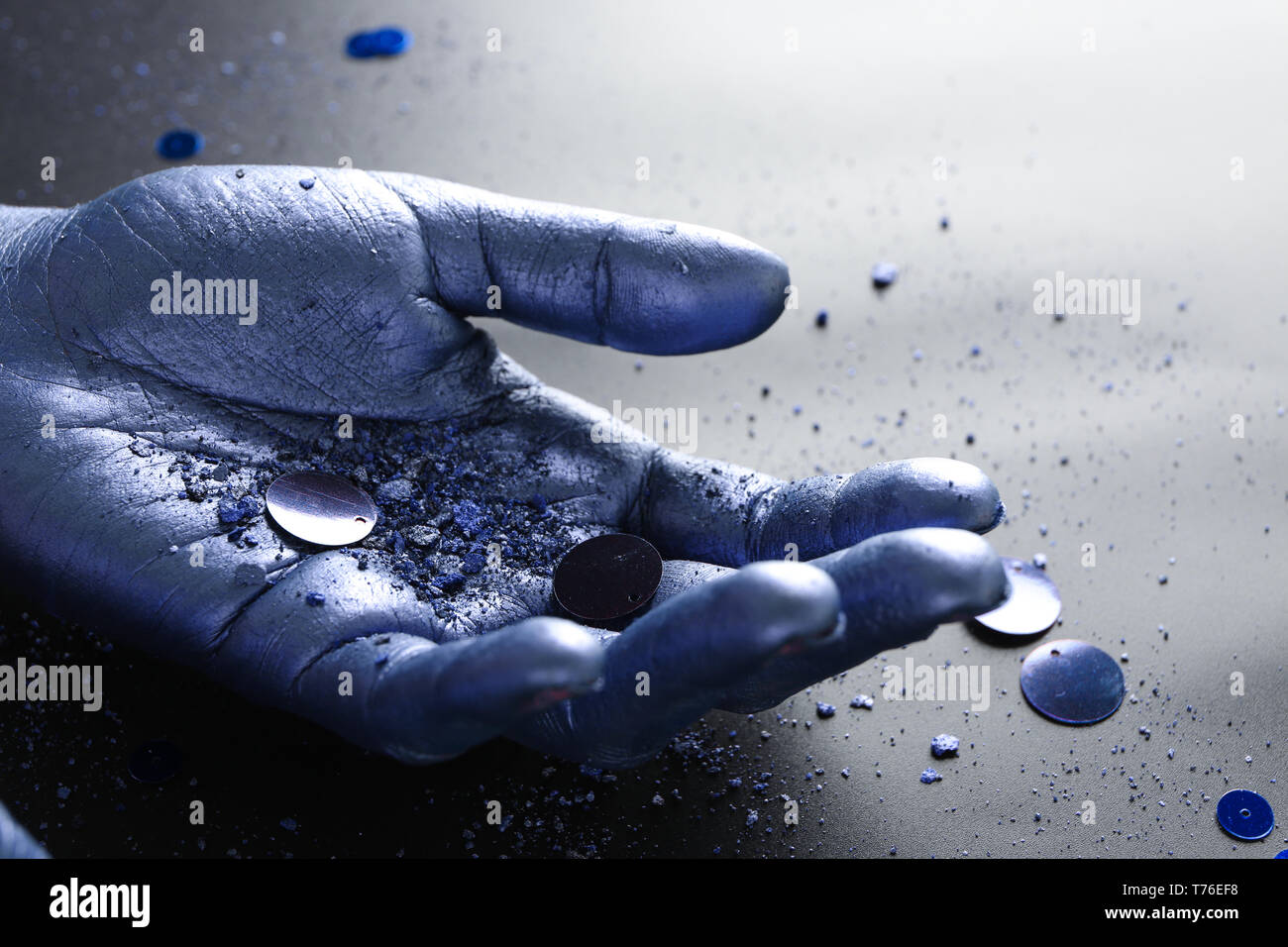 Purple human palm with sequins and powder on dark background Stock ...