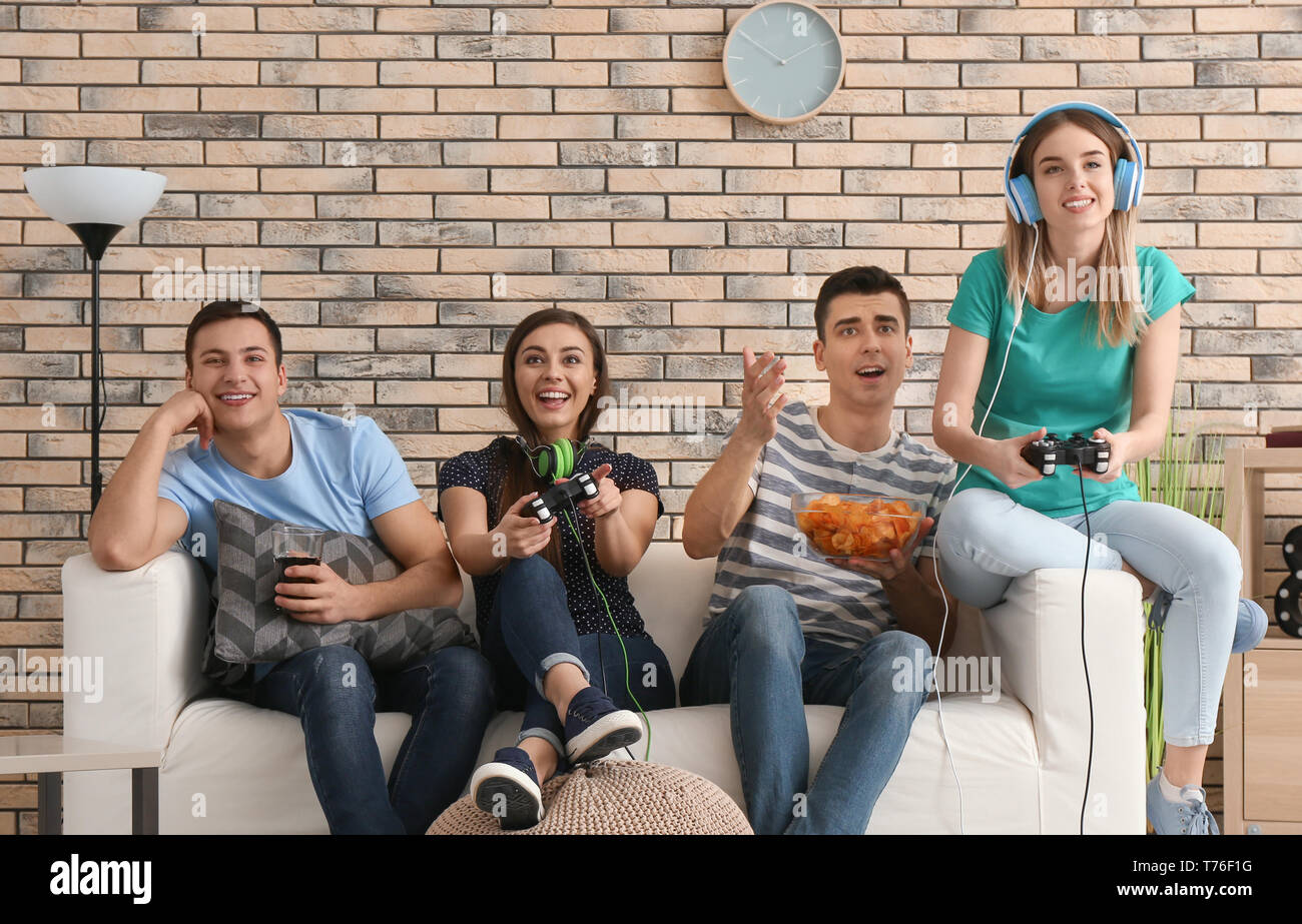 Young people playing video games at home Stock Photo - Alamy