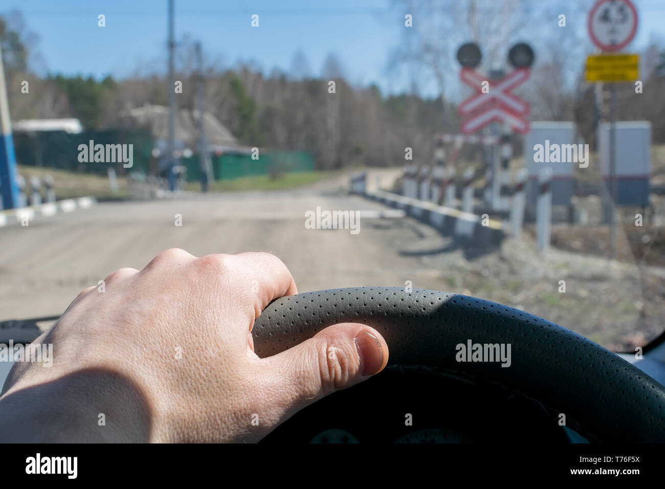 View of the driver's hand on the steering wheel of the car, which ...