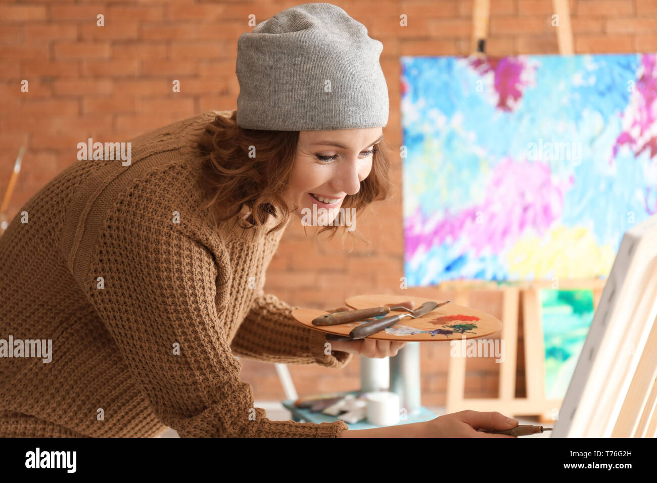 Woman artist paints abstract painting hi-res stock photography and ...