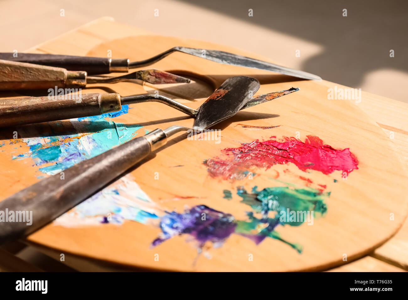 Tools on paint palette Stock Photo - Alamy