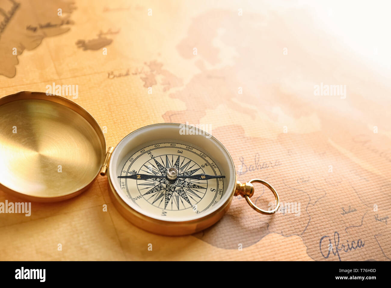 Compass on vintage world map Stock Photo - Alamy
