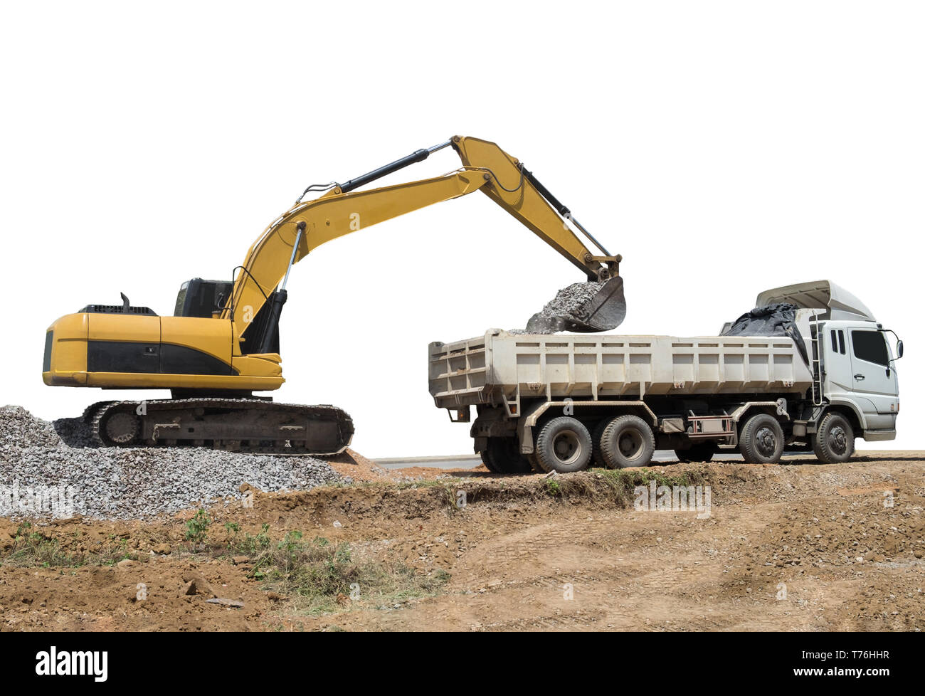 Backhoe heavy machine scoop rock onto the truck Stock Photo - Alamy