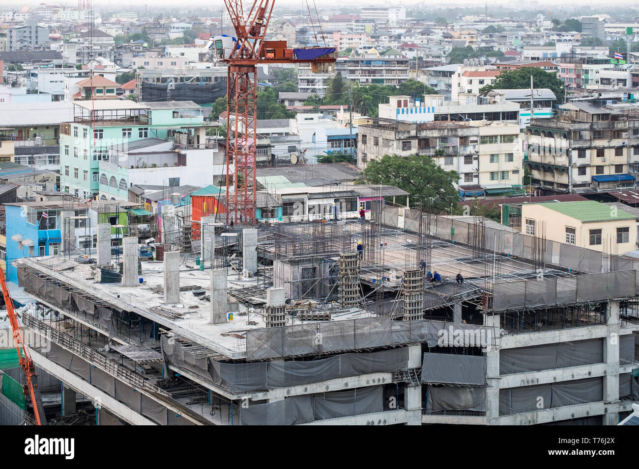 Construction industry worker and building tower Stock Photo - Alamy