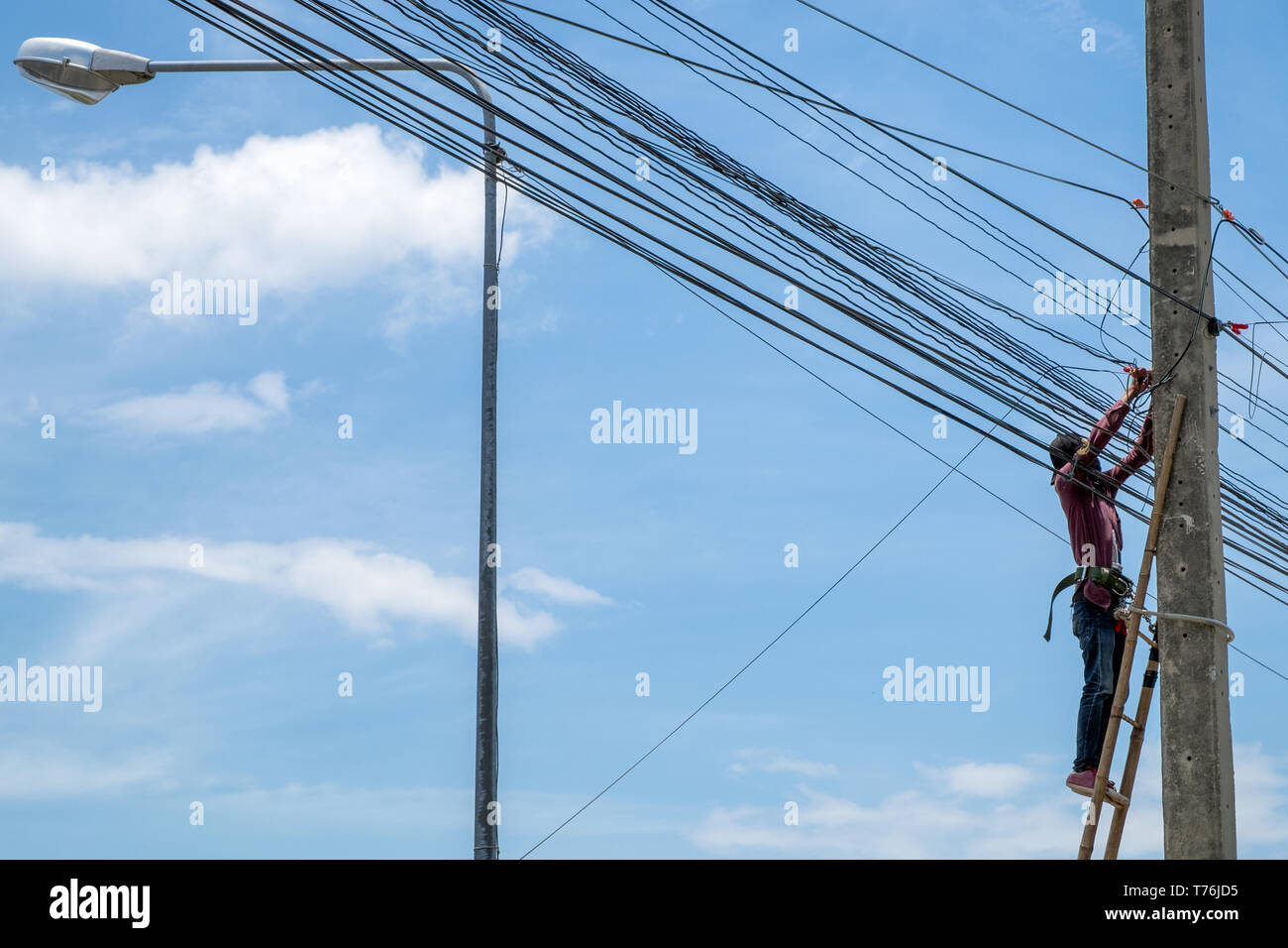 Electricity worker fixing power line hi-res stock photography and ...