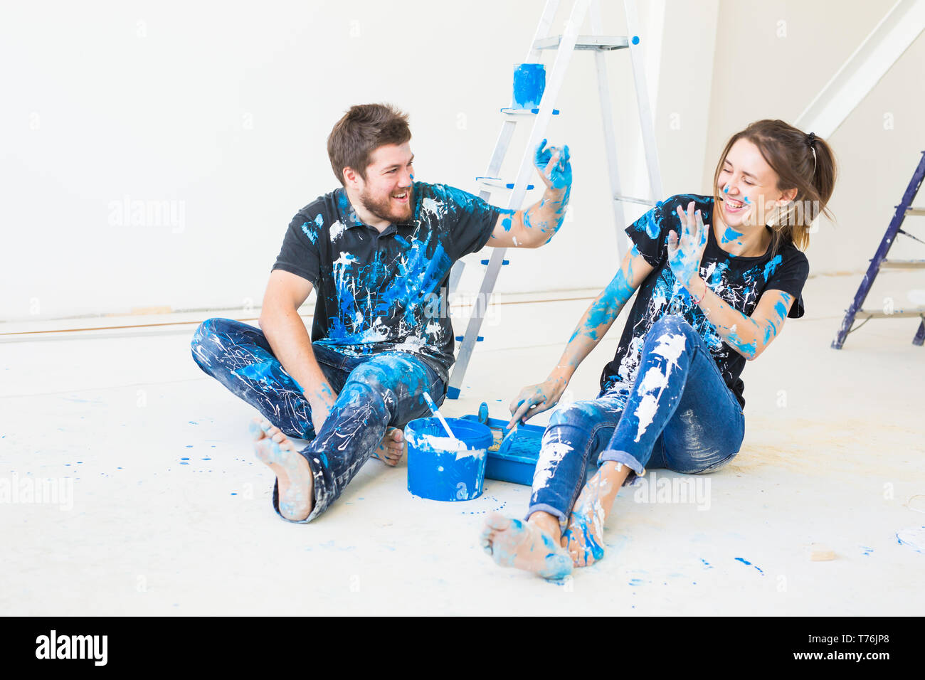 Renovation, redecoration and people concept - young couple doing a ...