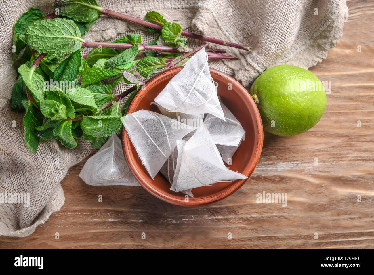 Bowl with tea bags on wooden table Stock Photo - Alamy