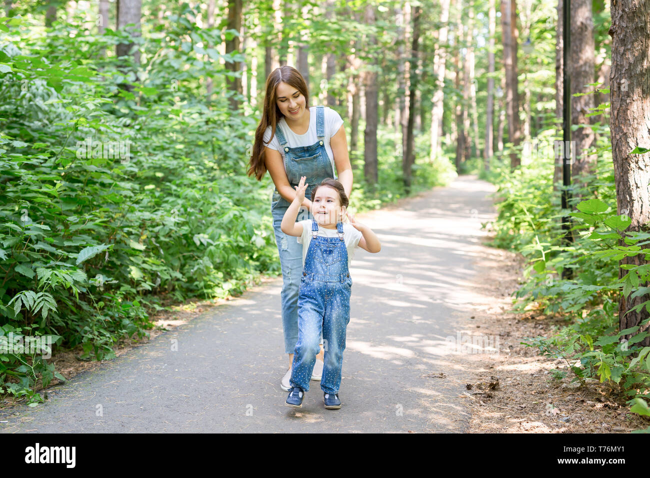 Family, parenthood and nature concept - Mother with daughter having fun ...