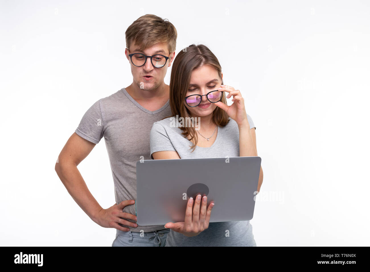 Nerds, study, people concept - a couple of people look at the laptop ...
