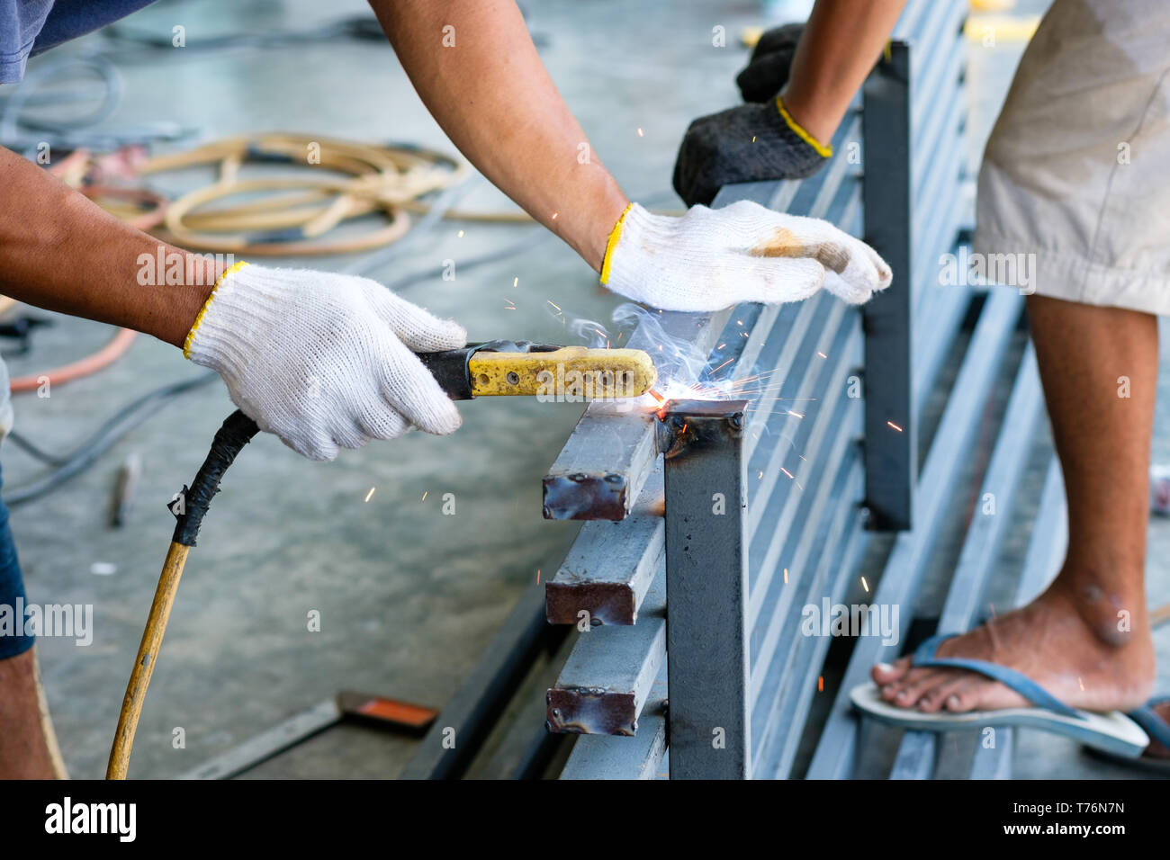 Industrial welder welding steel with sparks Stock Photo - Alamy