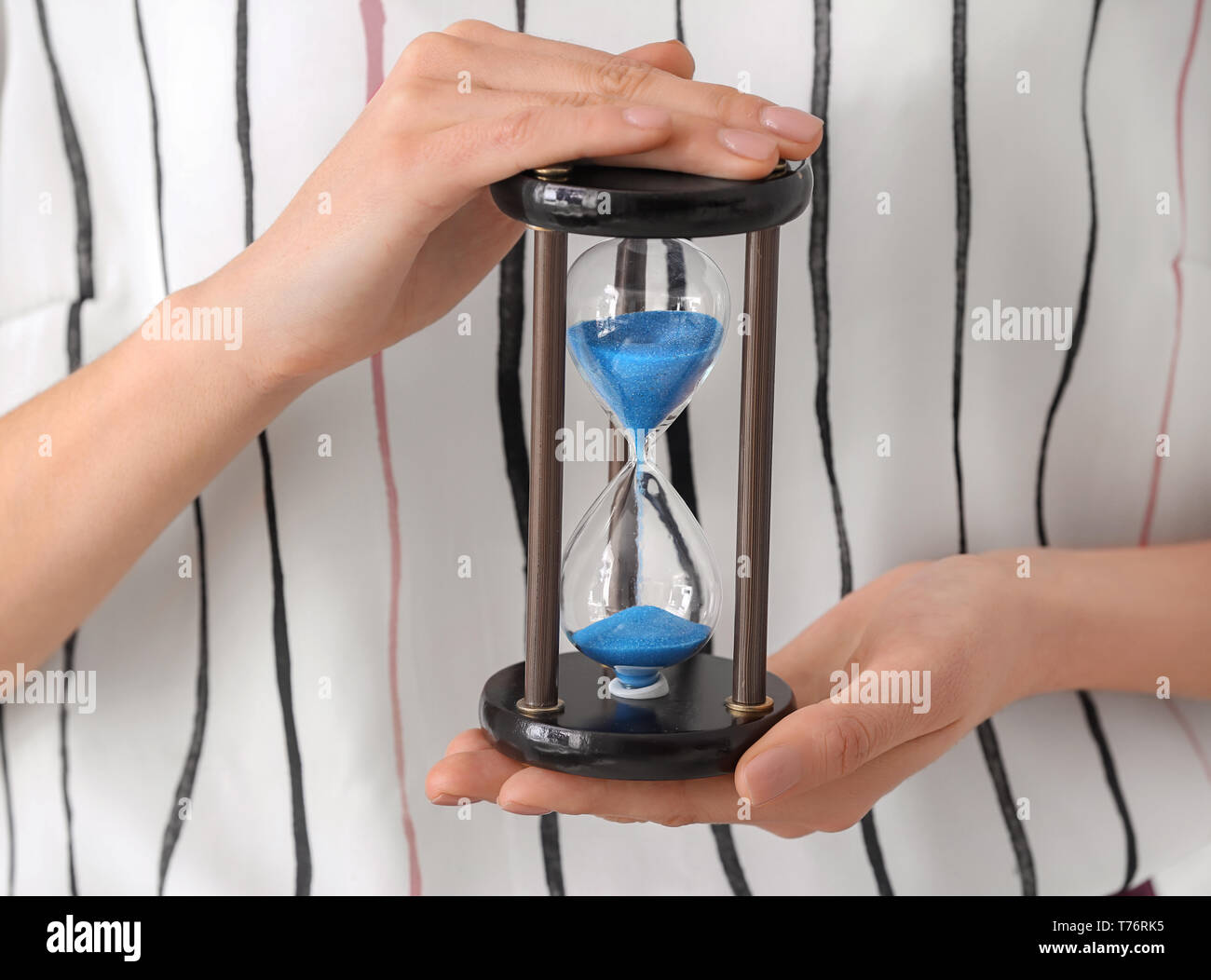 Holding hourglass hi-res stock photography and images - Alamy