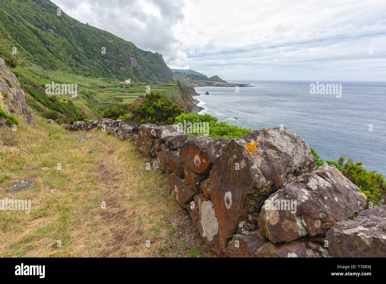 Beautiful rock wall next to a hiking path near Ponta da Faja village on ...