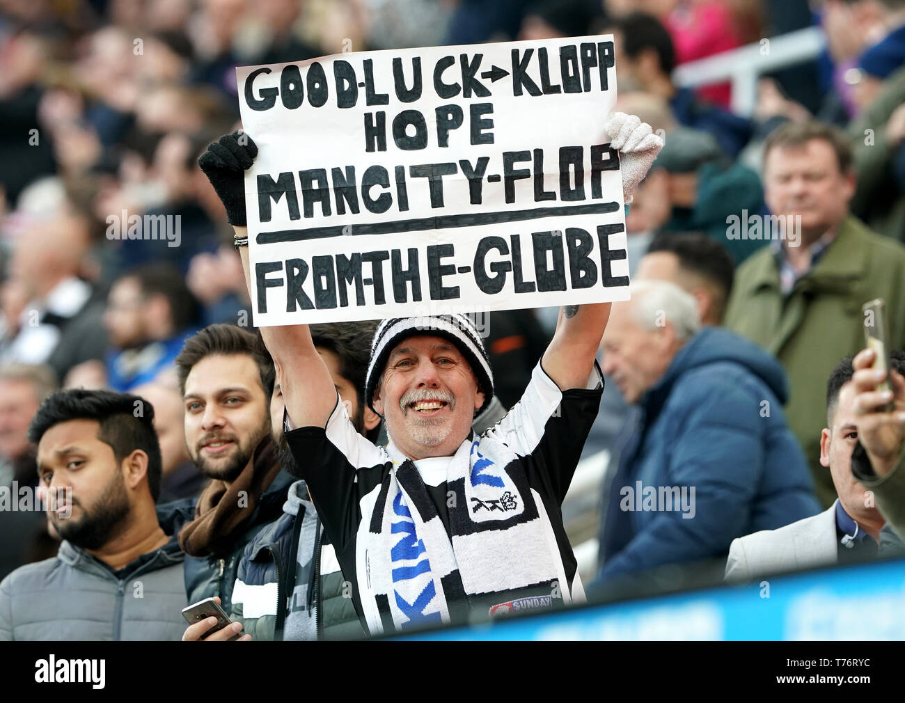 A Newcastle United fan holds up a banner in the stands before the ...