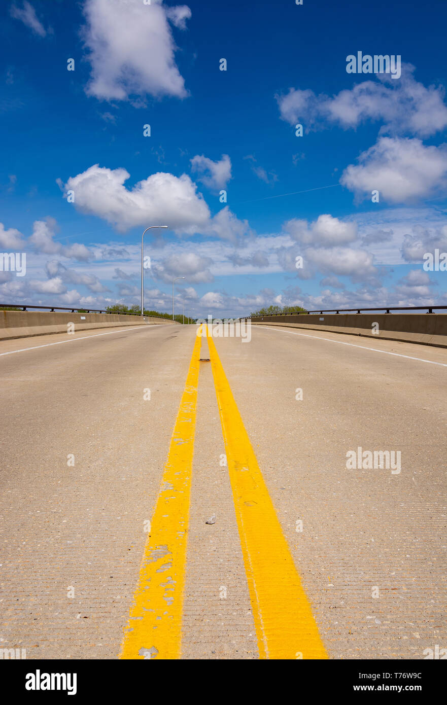 Open two lane road over a bridge with blue skies and clouds above Stock ...