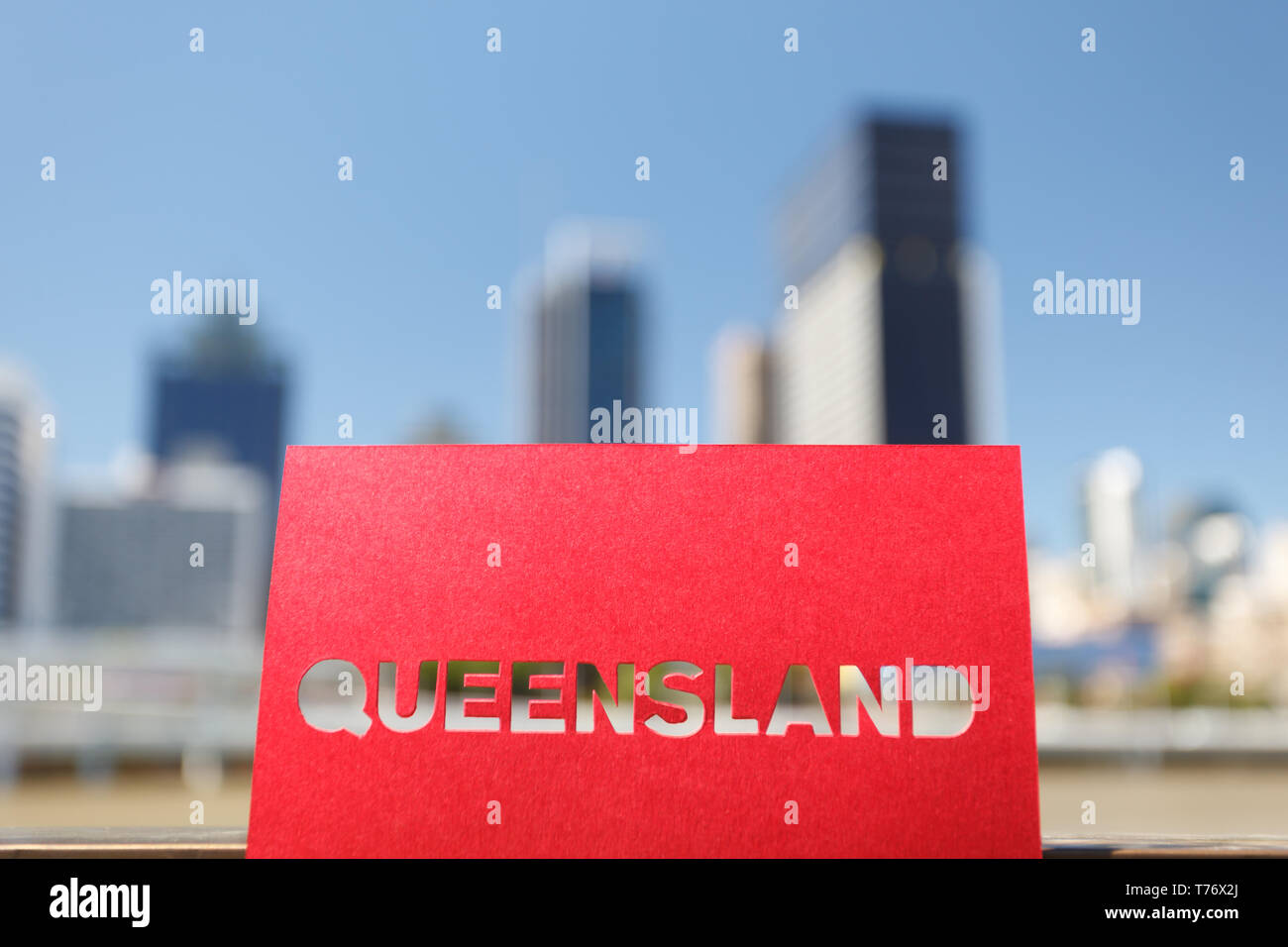 Red Queensland Australia road sign with city of Brisbane skyline behind ...