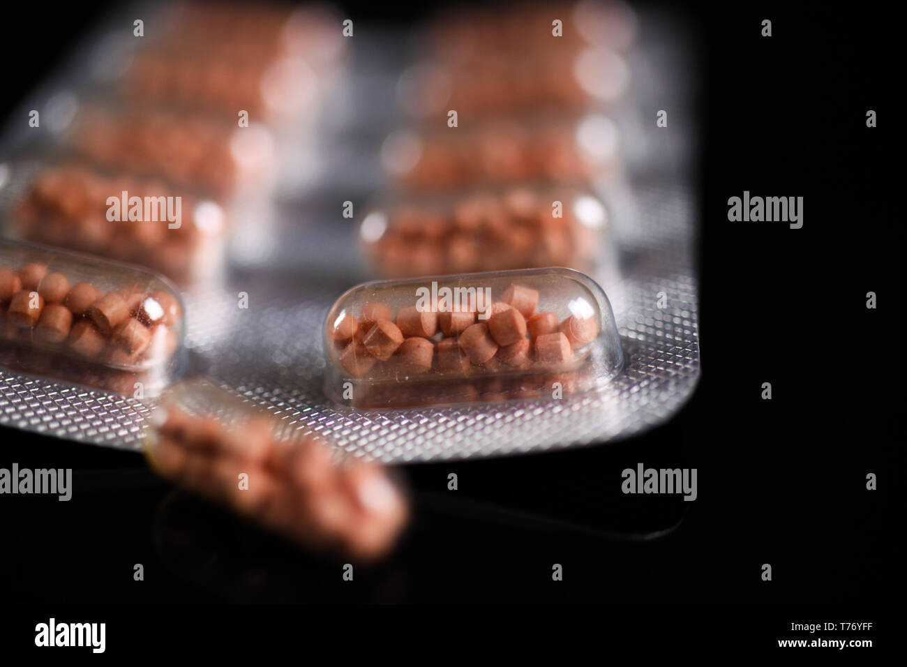 Makro close up of capsule pills in silver blister package and one ...