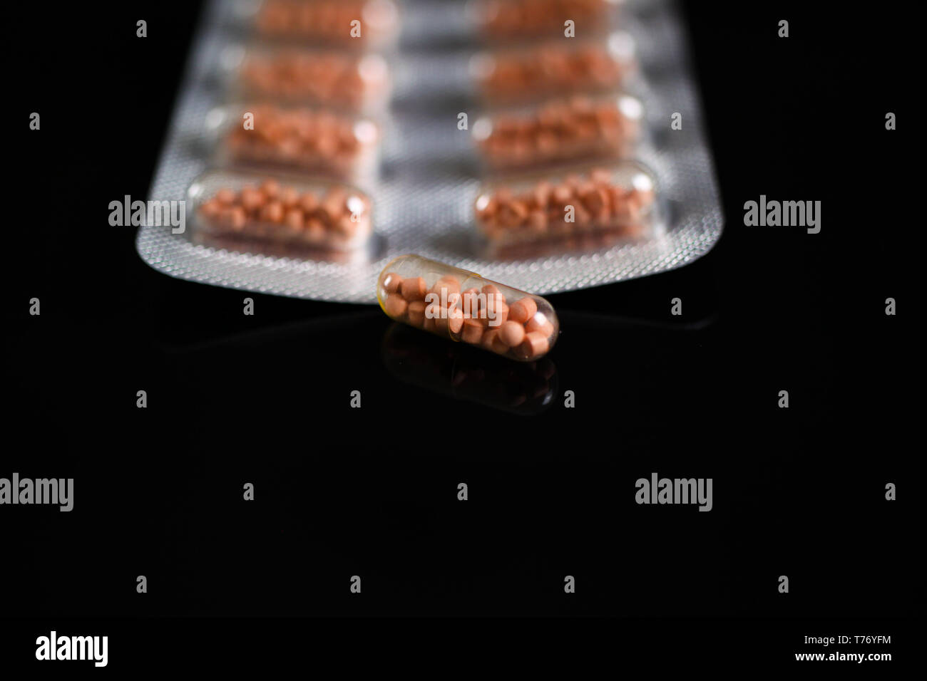 Makro close up of capsule pills in silver blister package and one ...
