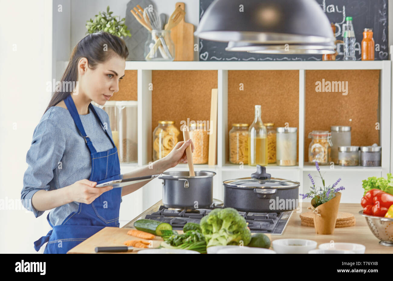 Beautiful female chef cooking home hi-res stock photography and images ...