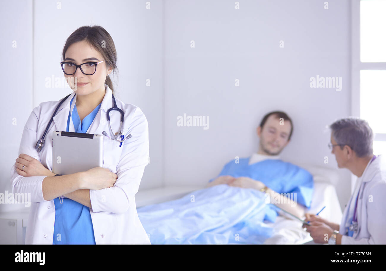Doctor checking heart beat of patient in bed with stethoscope Stock ...