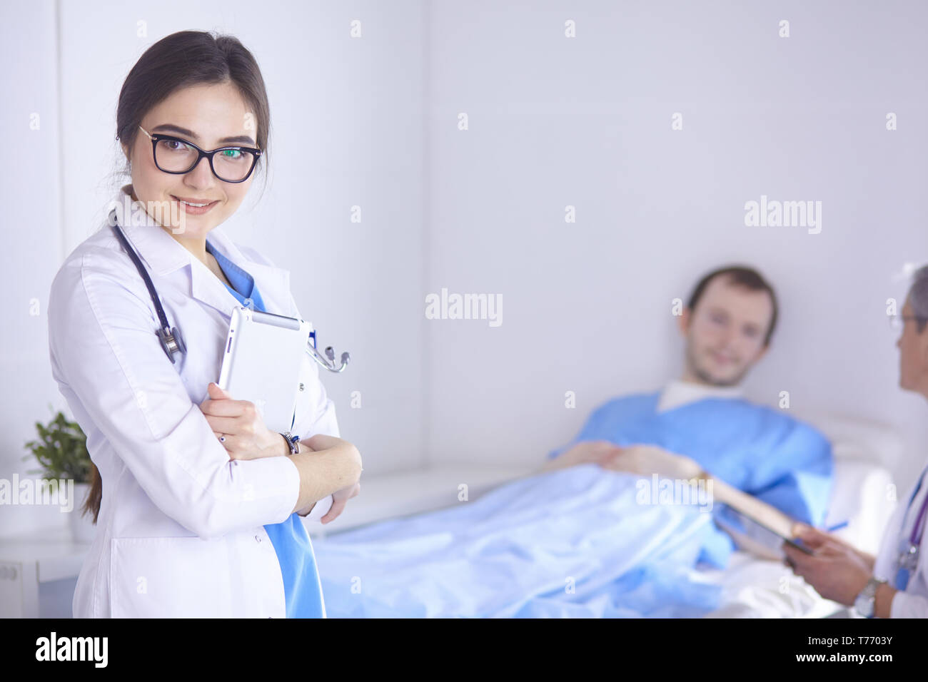 Doctor checking heart beat of patient in bed with stethoscope Stock ...