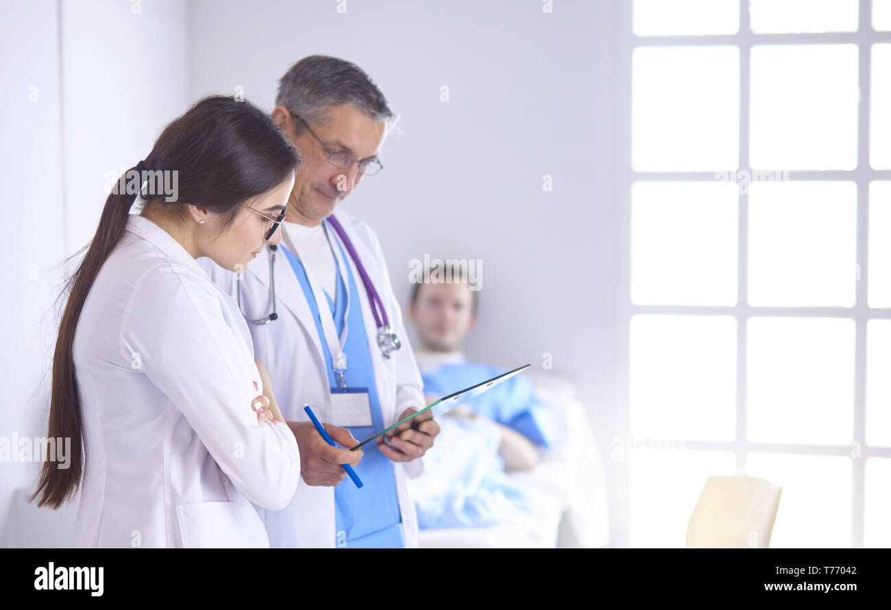 Doctor checking heart beat of patient in bed with stethoscope Stock ...