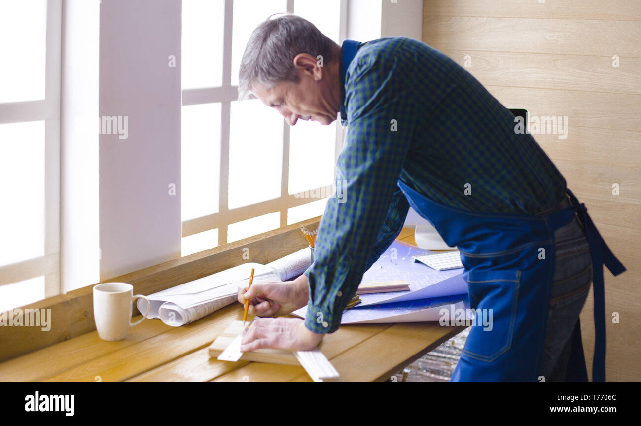 Engineer carpenter working on laptop and sketching project Stock Photo ...