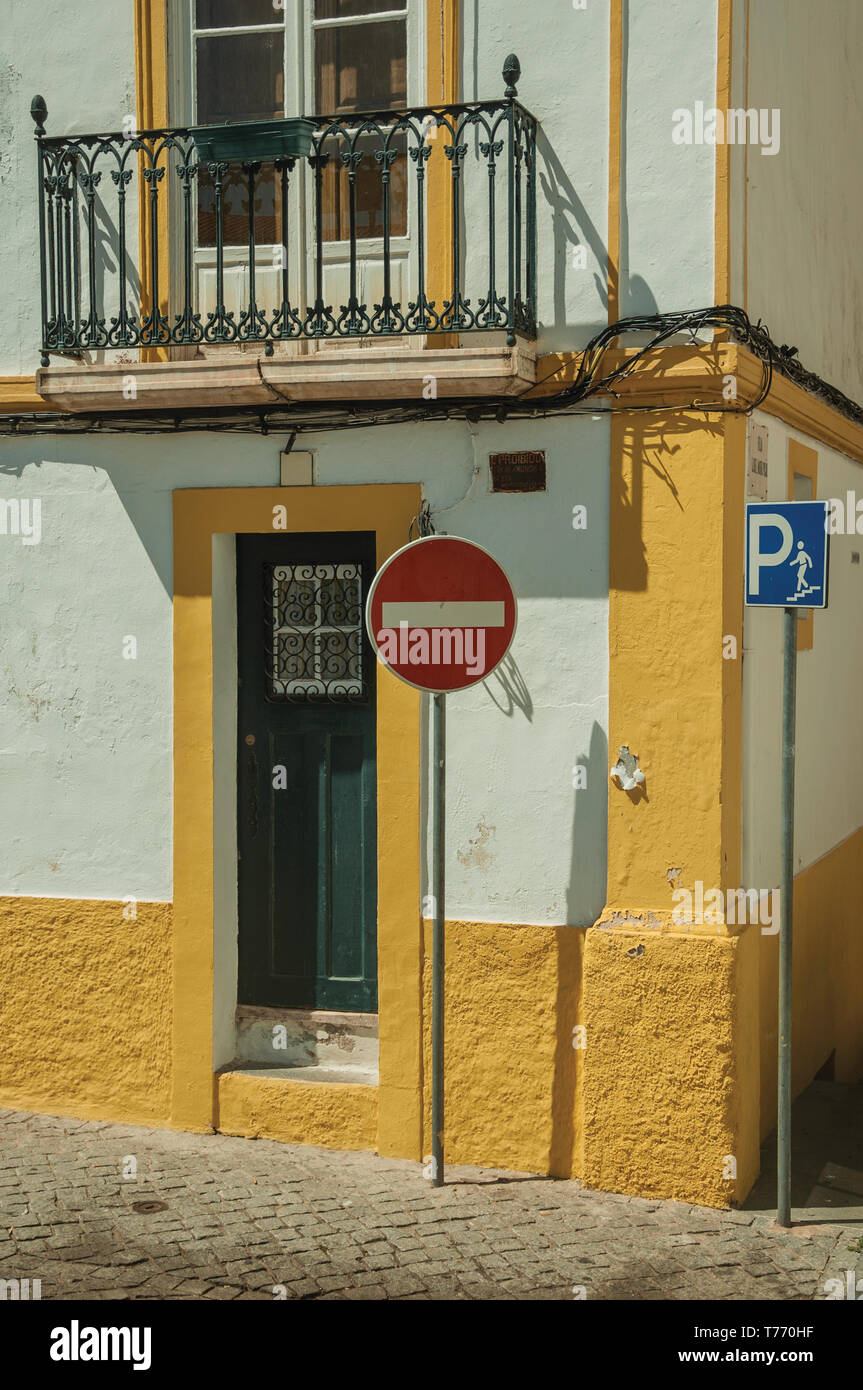 NO ENTRY road sign in front of old building facade with rustic door and ...