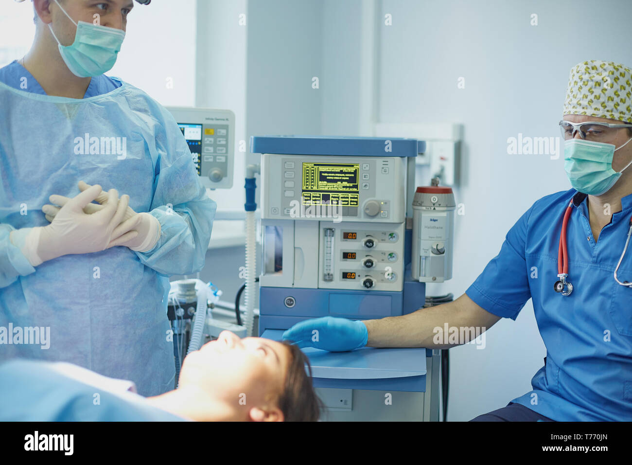 Several doctors surrounding patient on operation table during their ...